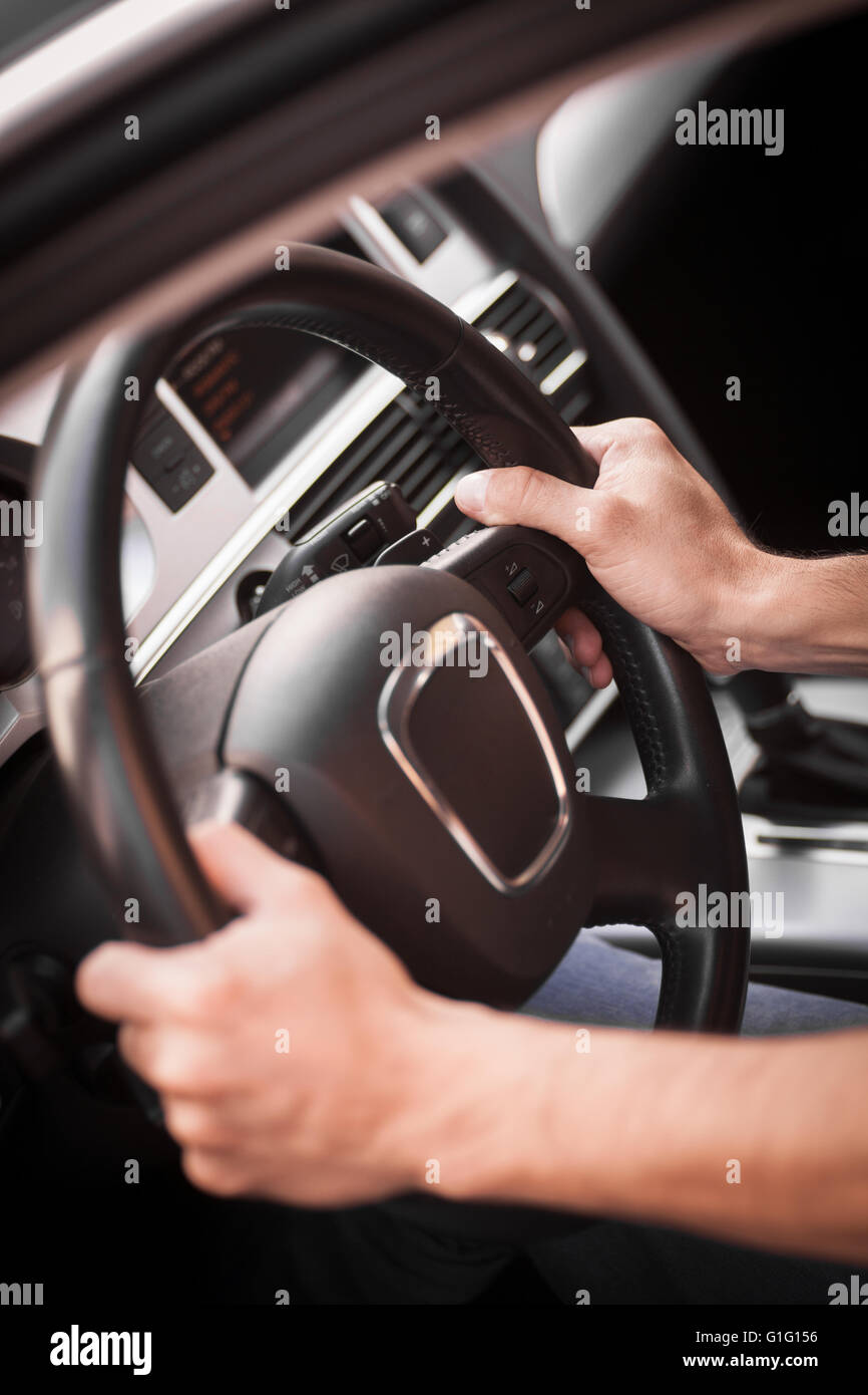Color image of two hands holding a steering wheel inside a car Stock ...