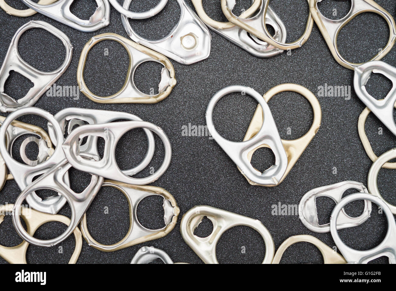 Ring pull cans opener on black metallic background Stock Photo - Alamy