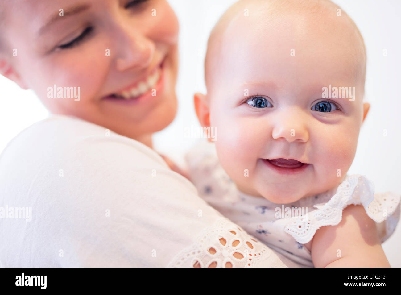 Smiling and cute baby girl with her mother Stock Photo - Alamy
