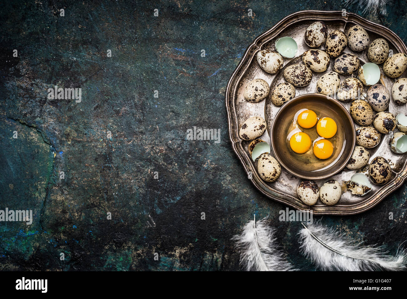 Quail eggs in vintage plate on rustic background, top view, place for ...
