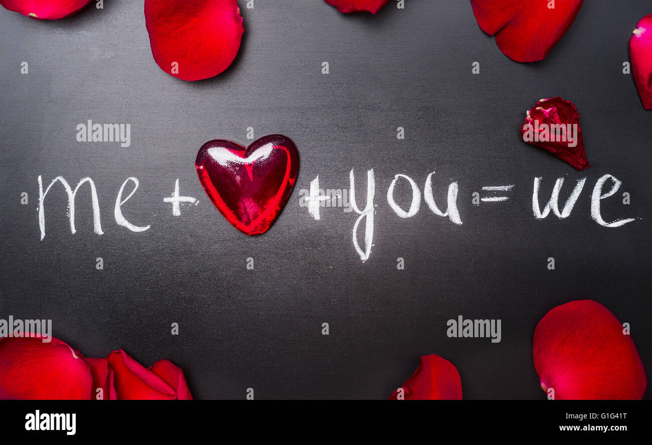 Valentines day lettering background with red hearts and rose petals ...