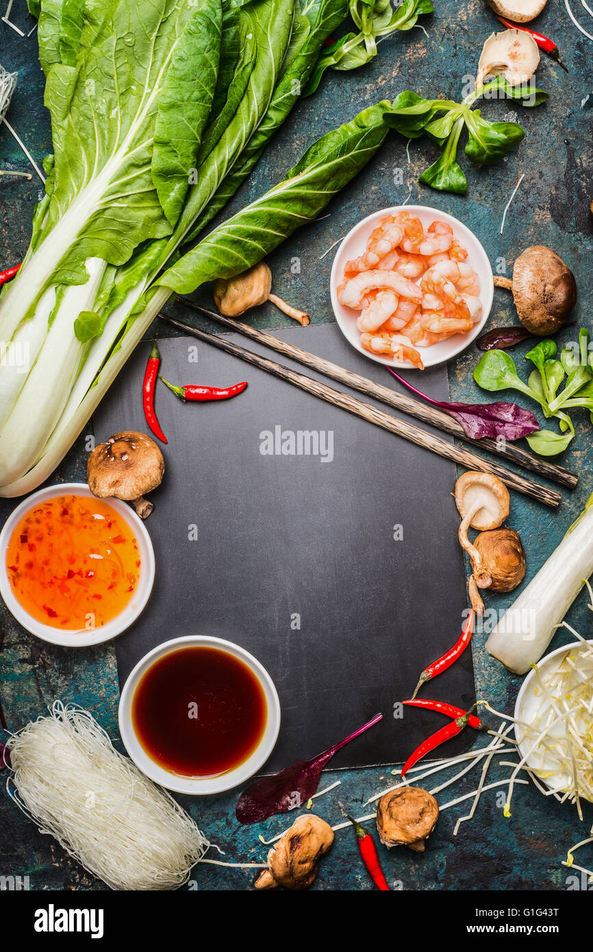 Asian food background with cooking ingredients, chopsticks and sauces ...