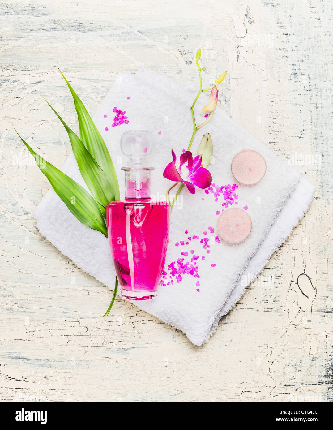 Elegant bottle of lotion , pink orchid flowers and green bamboo leaves ...