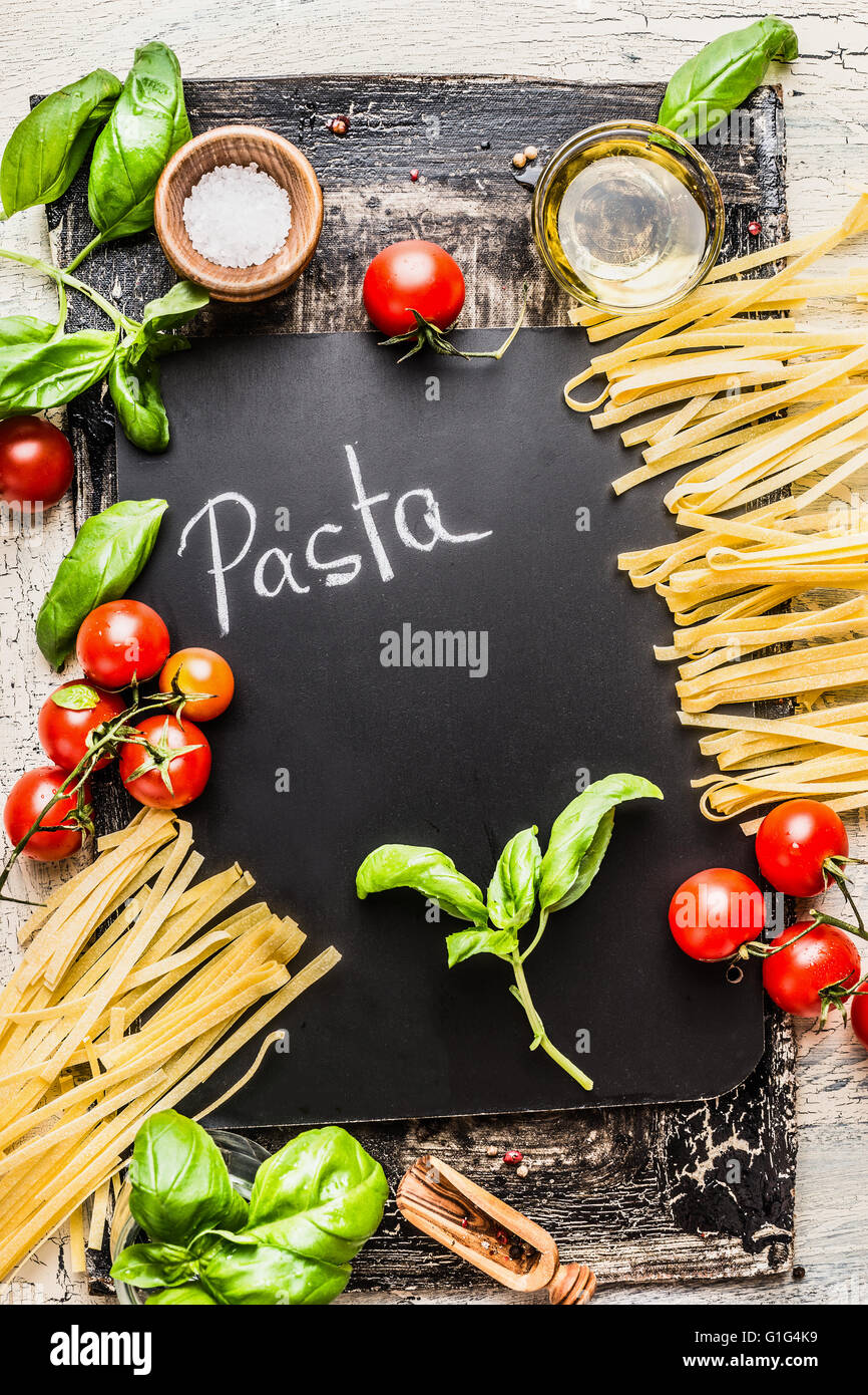Pasta cooking background with chalkboard, tomatoes, basil and olive oil ...