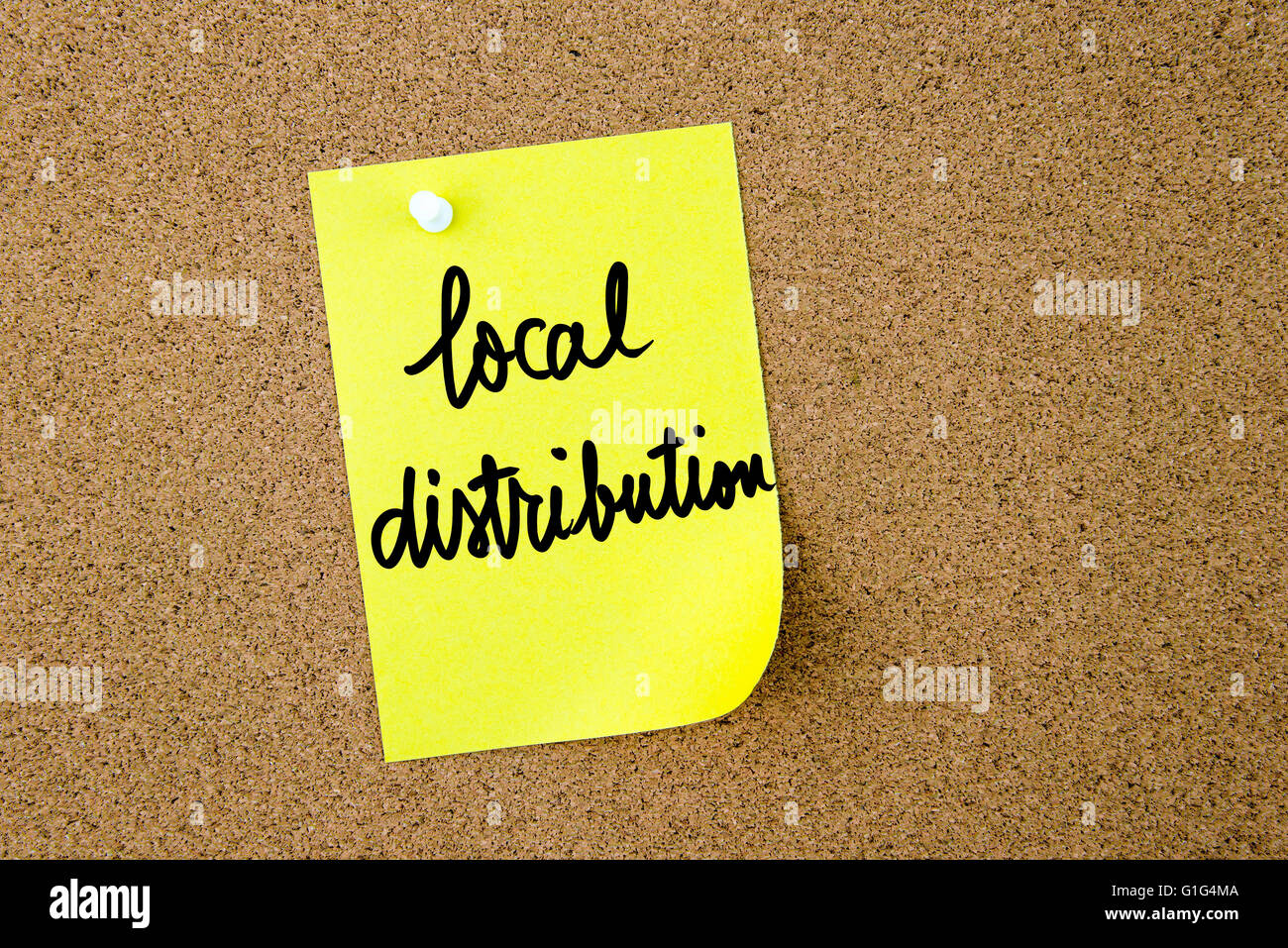 Local Distribution written on yellow paper note pinned on cork board ...