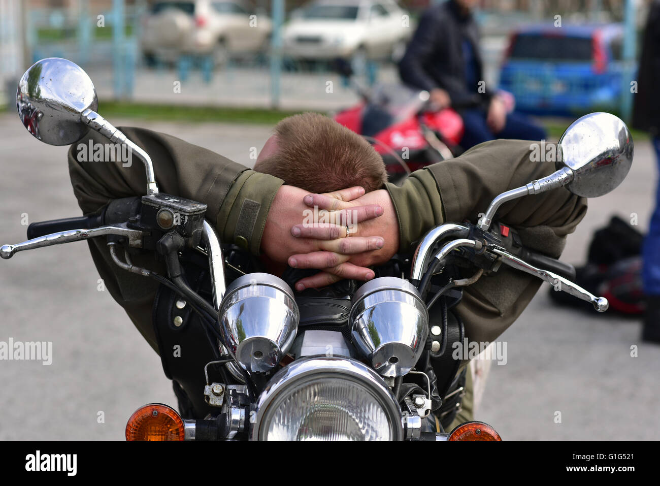 Motorcyclist resting on his bike Stock Photo - Alamy