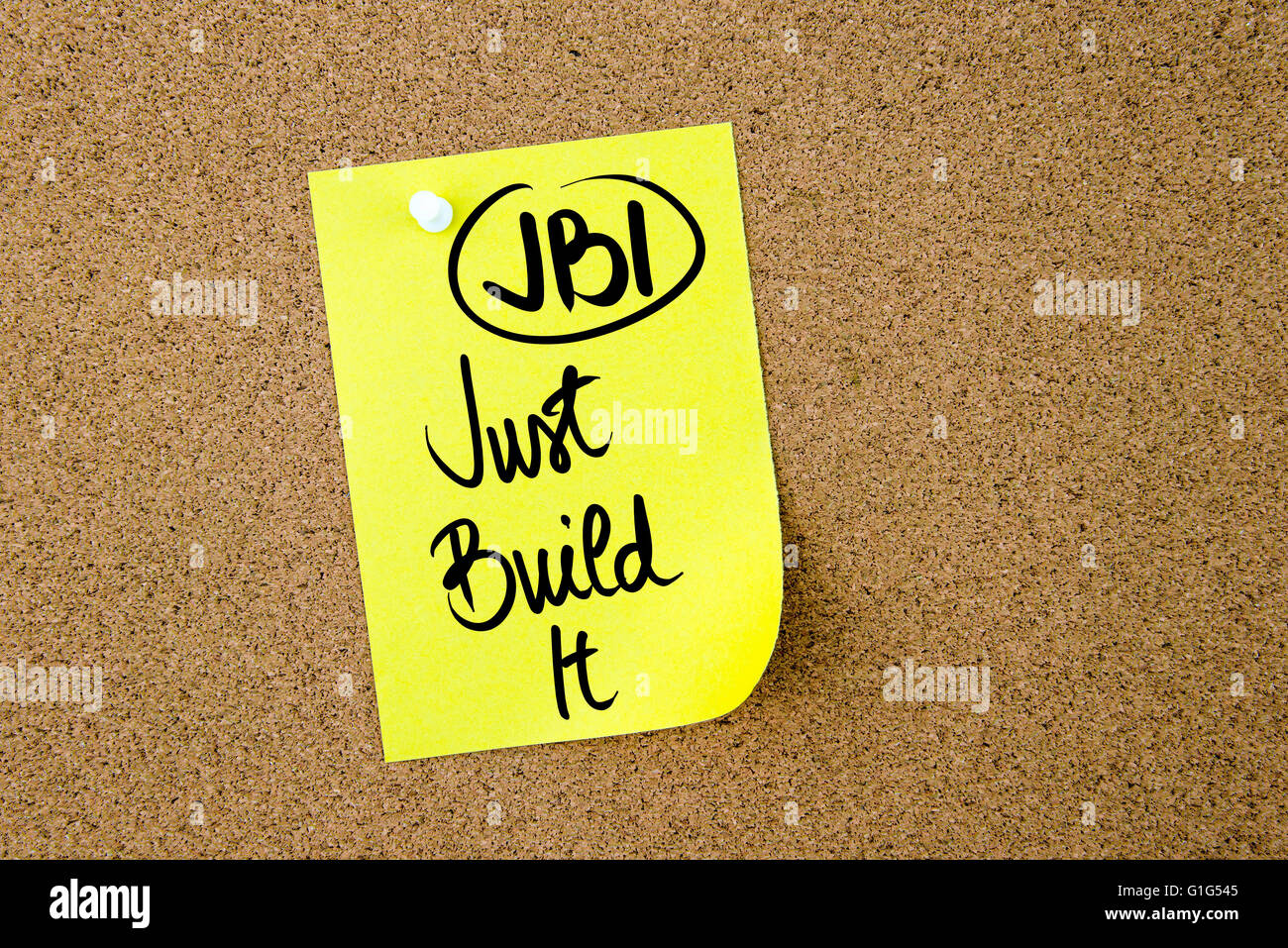 Business Acronym JBI Just Build It written on yellow paper note pinned ...