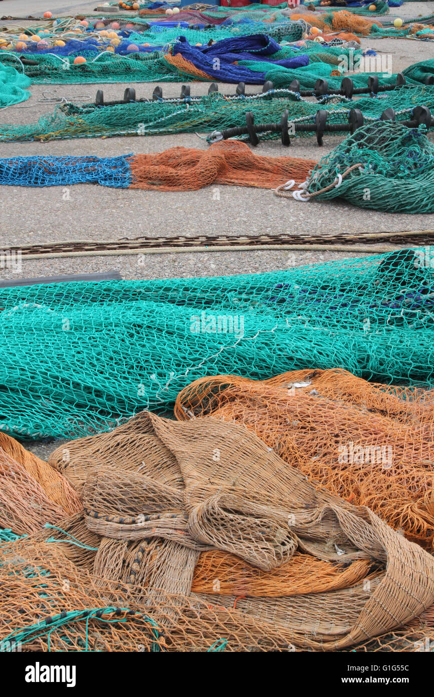Colourful colorful fishing nets on harbour side harbor Stock Photo - Alamy