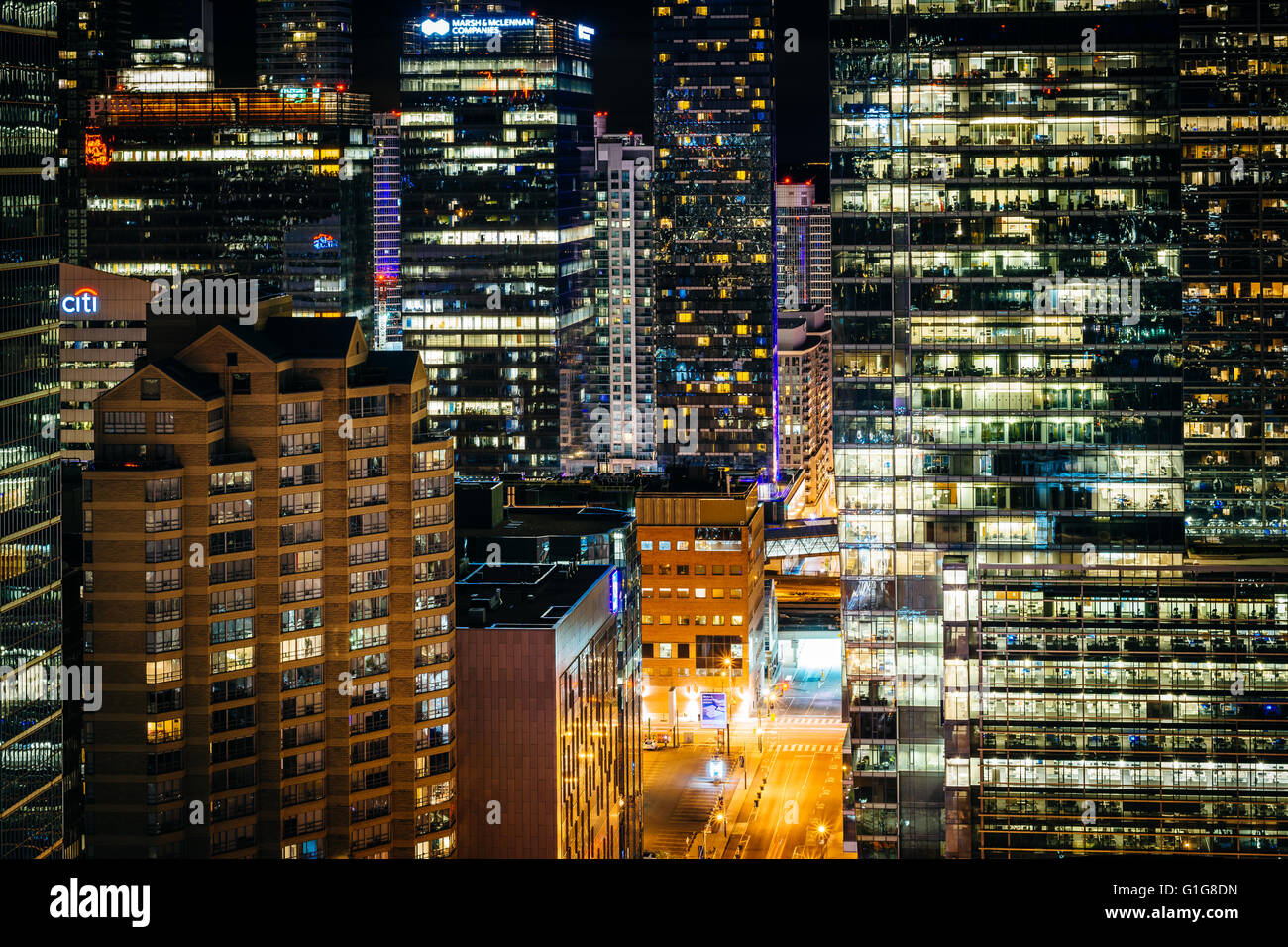 View of modern buildings along Simcoe Street at night, in the Financial ...
