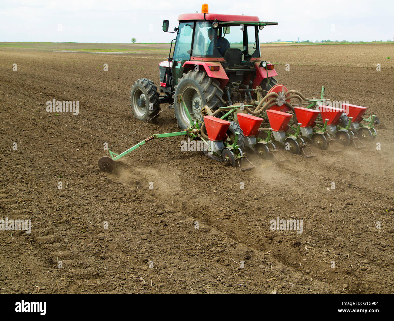 Young farmer sowing crops at field with pneumatic sowing machine Stock ...