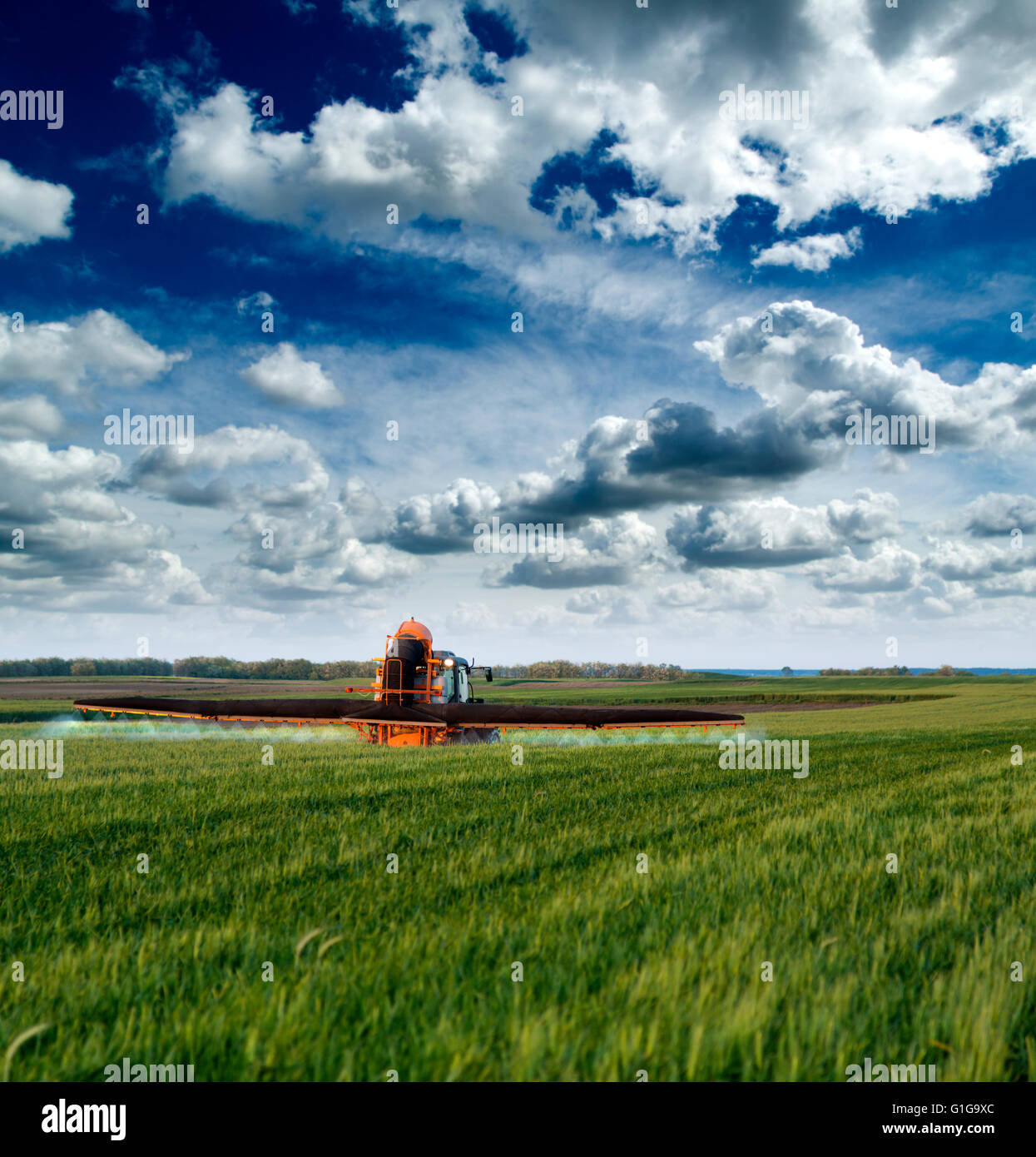Spraying crops field Stock Photo - Alamy