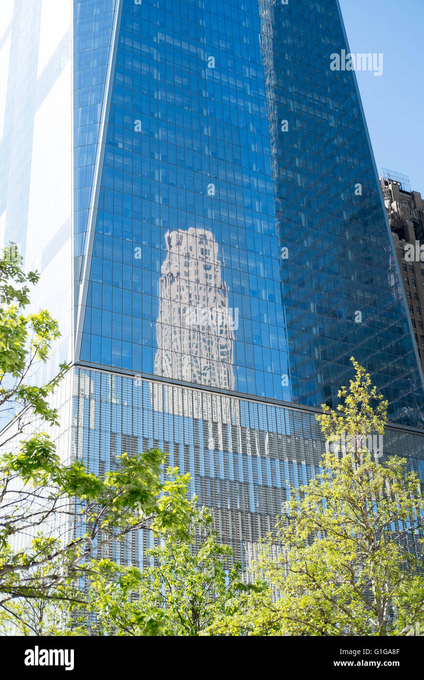 Skyscraper reflected in the glass of the World Trade Center memorial in ...