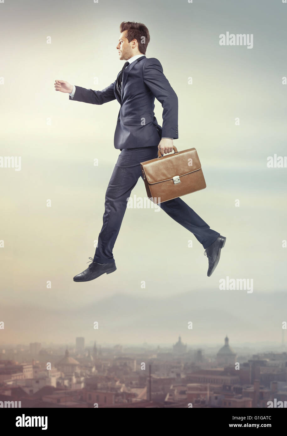Picture presenting flying businessman with briefcase Stock Photo - Alamy