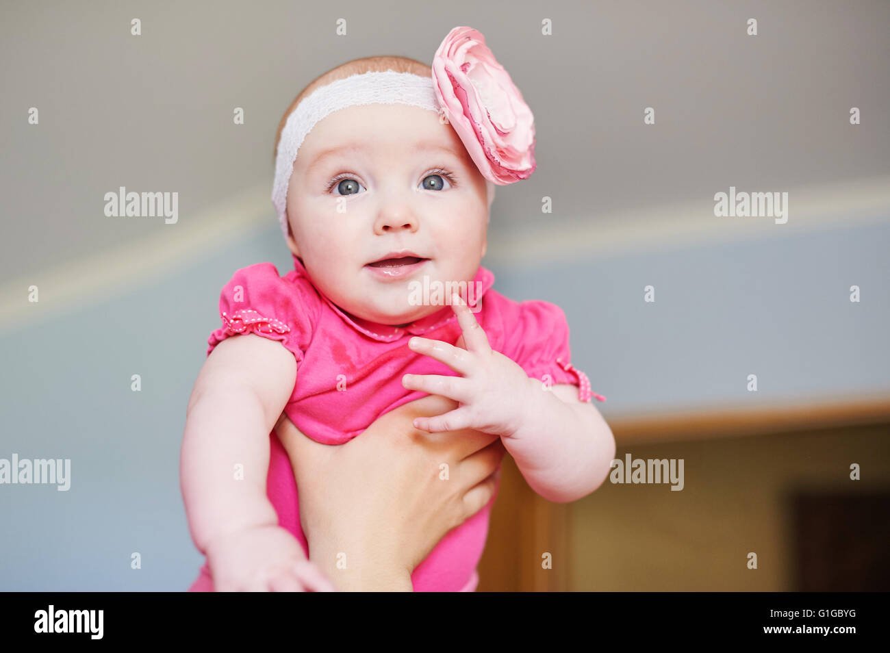 portrait of cute little baby girl with pink bow flower on her head ...