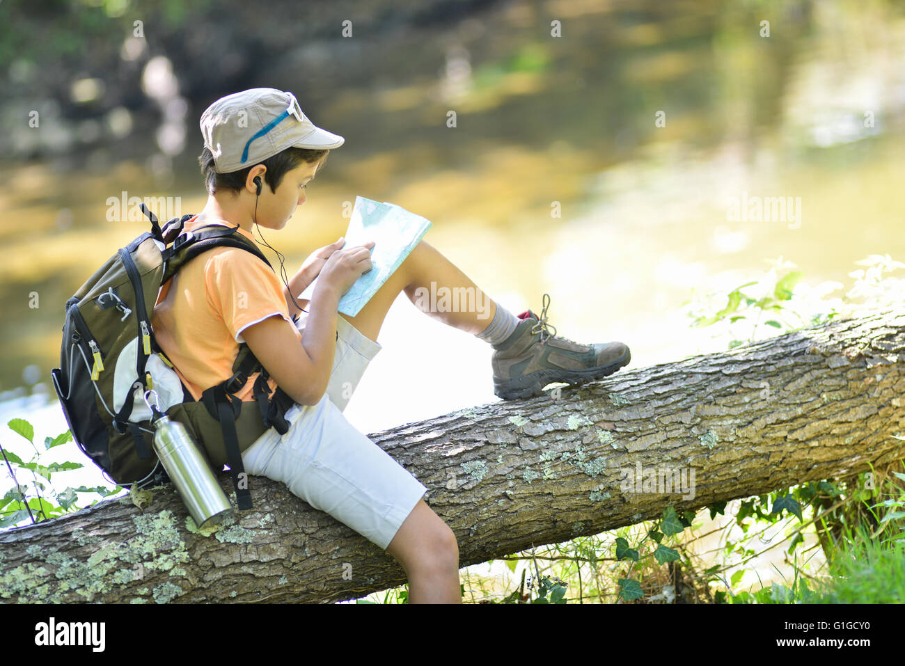 Young boy seeking his path on a map during a hike Stock Photo - Alamy