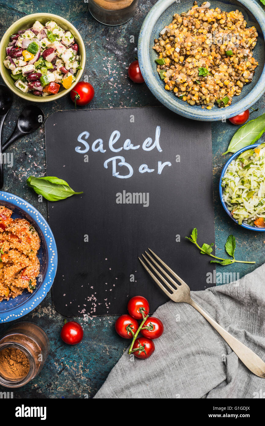 Salad bar with various healthy vegetarian salads dish, forg and black ...