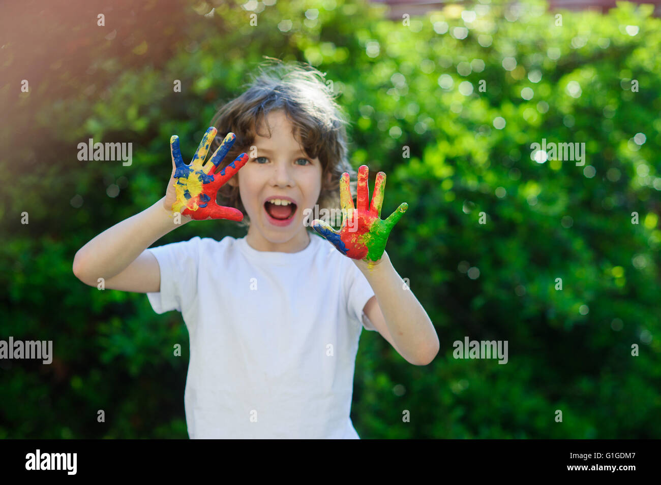 The boy shows his colorful hands Stock Photo - Alamy