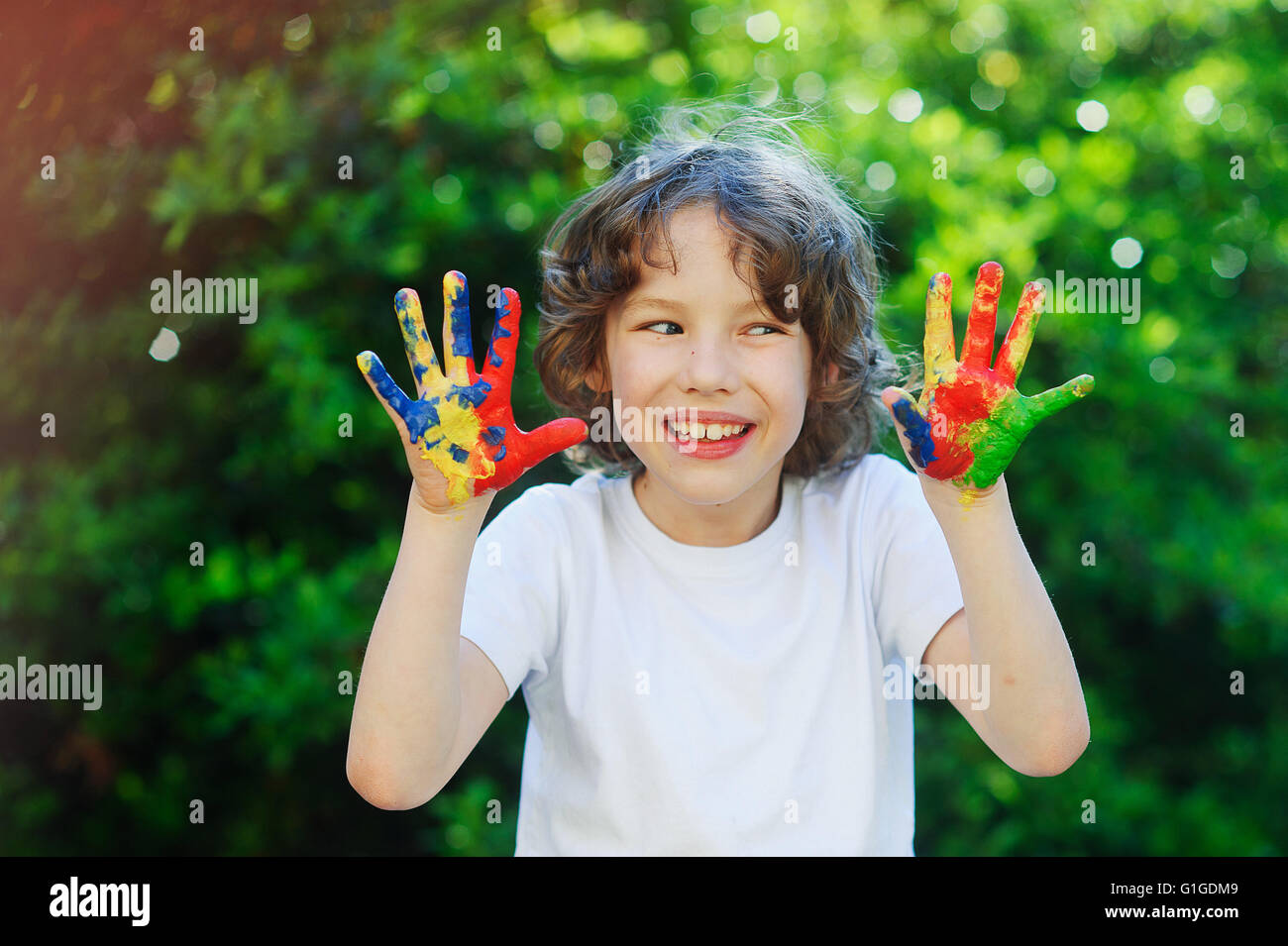 Young boy smile and show his colorful hands Stock Photo - Alamy
