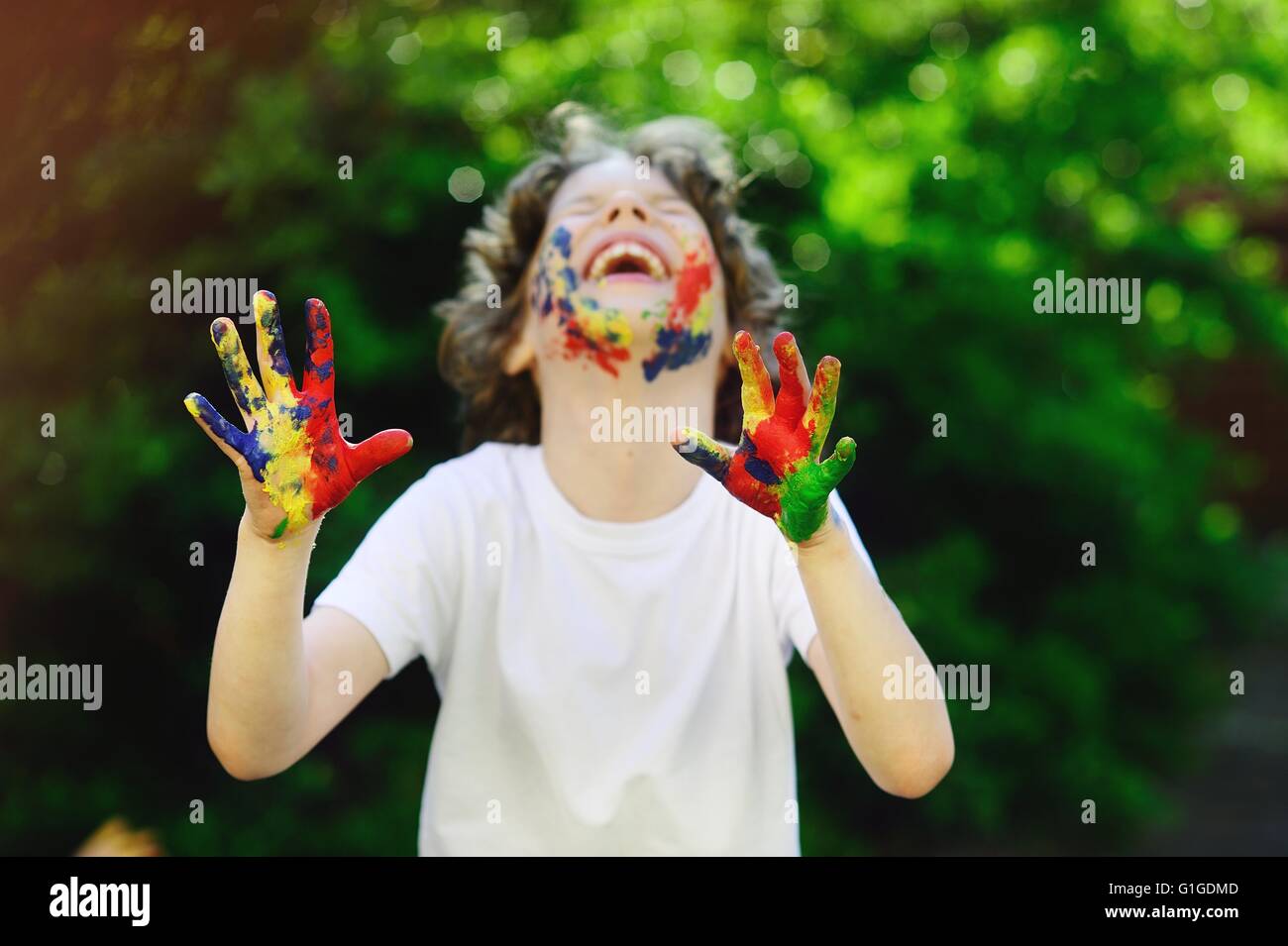 The boy's face and hands in the paint Stock Photo - Alamy