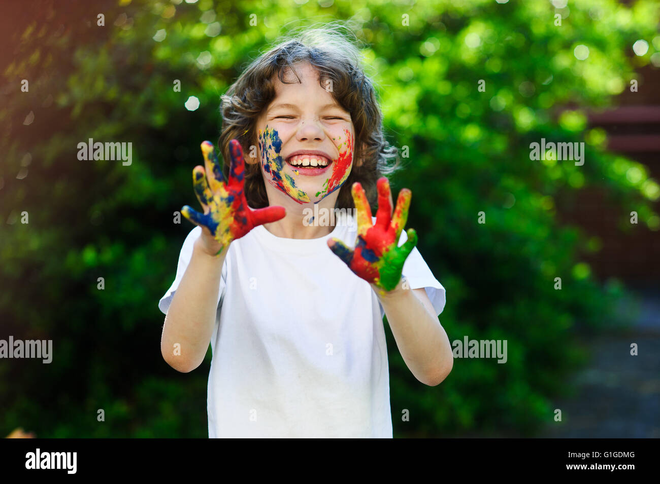 The boy's face and hands in paint Stock Photo - Alamy