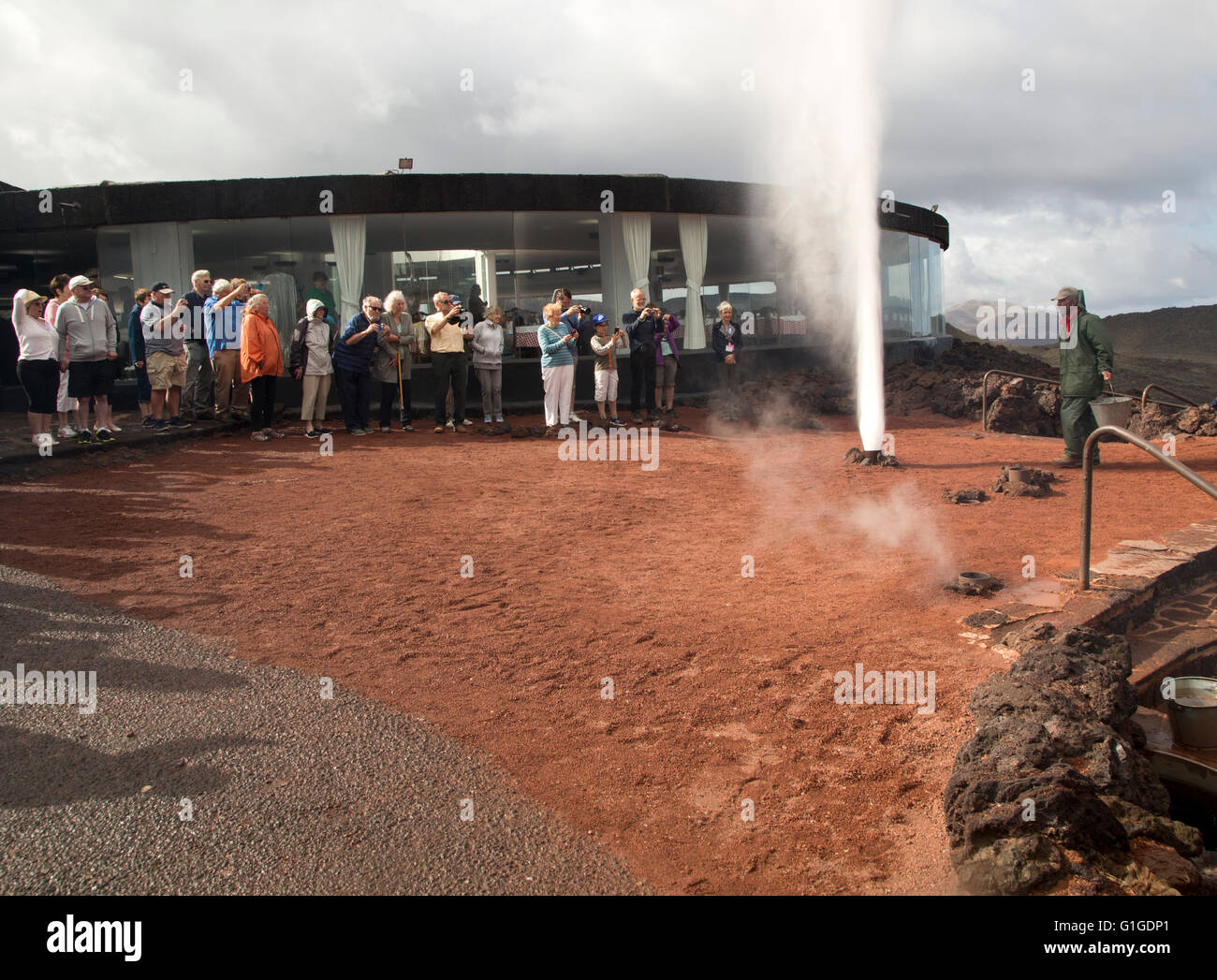 Tourists watch steam rise from geyser spout, Parque Nacional de ...