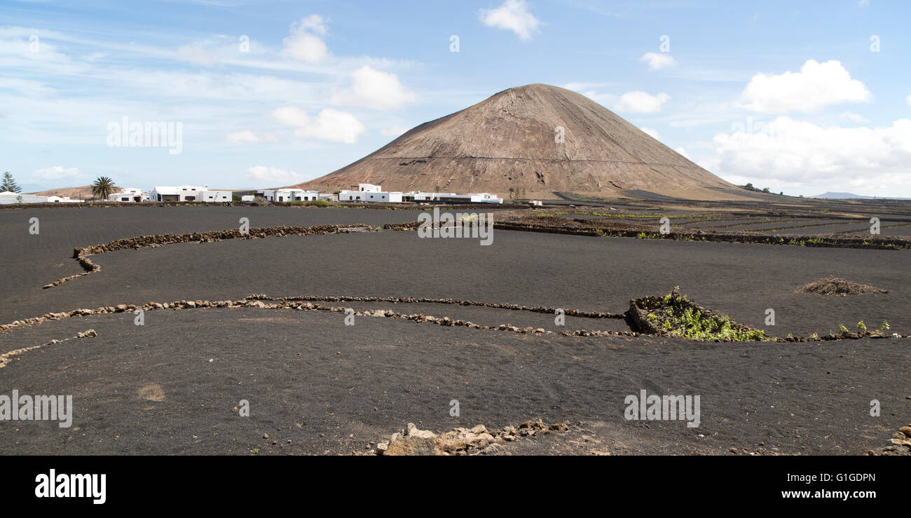 Volcano cone and black volcanic soil farmland hi-res stock photography ...