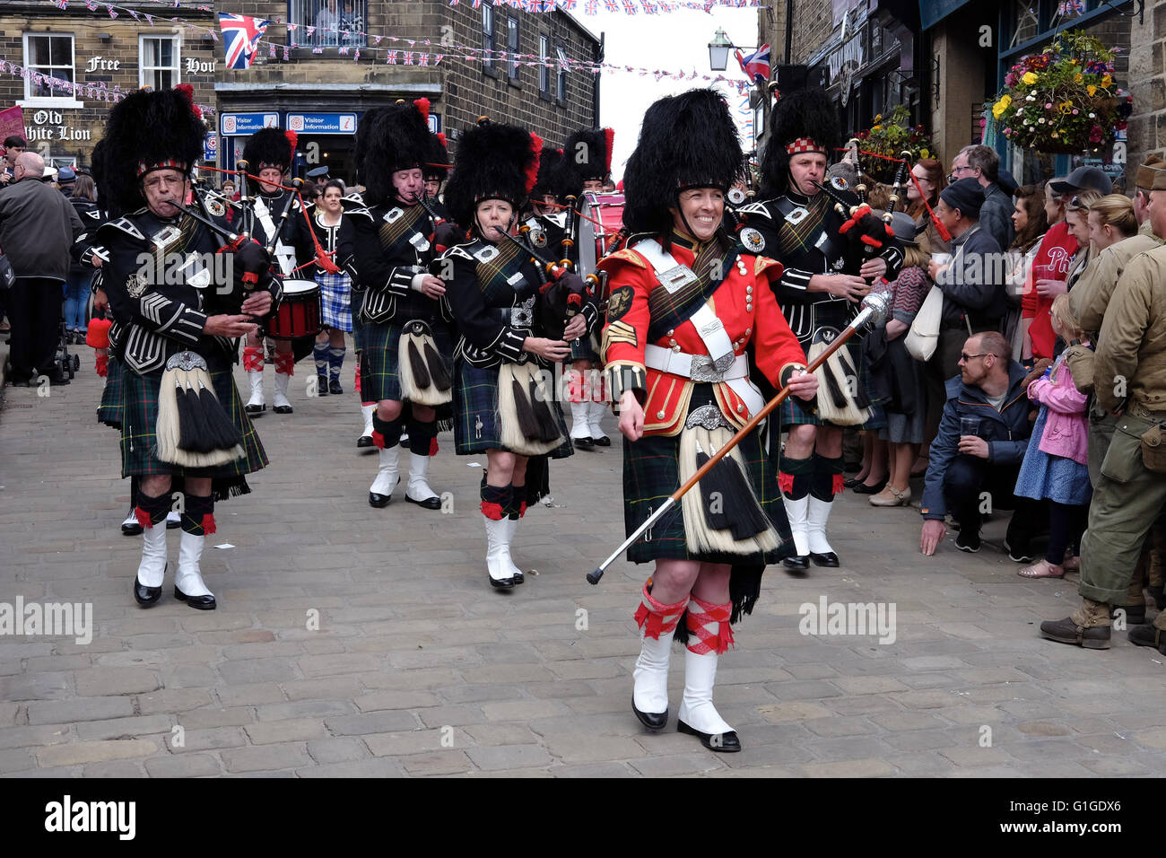 Durham pipe band marching down Haworth high street surrounded by crowds ...