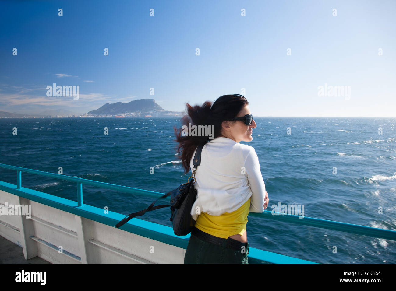 Woman leaning on yellow railing hi-res stock photography and images - Alamy