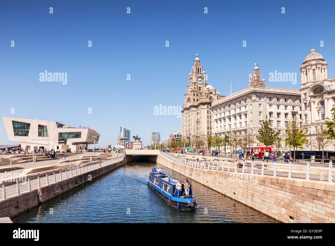 A narrowboat passing through the Liverpool Canal Link, in front of the ...