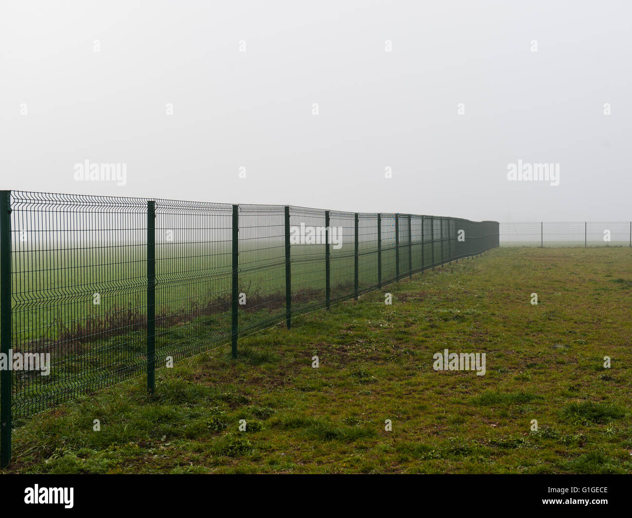 metal fence in the foggy day, rural landscape Stock Photo - Alamy