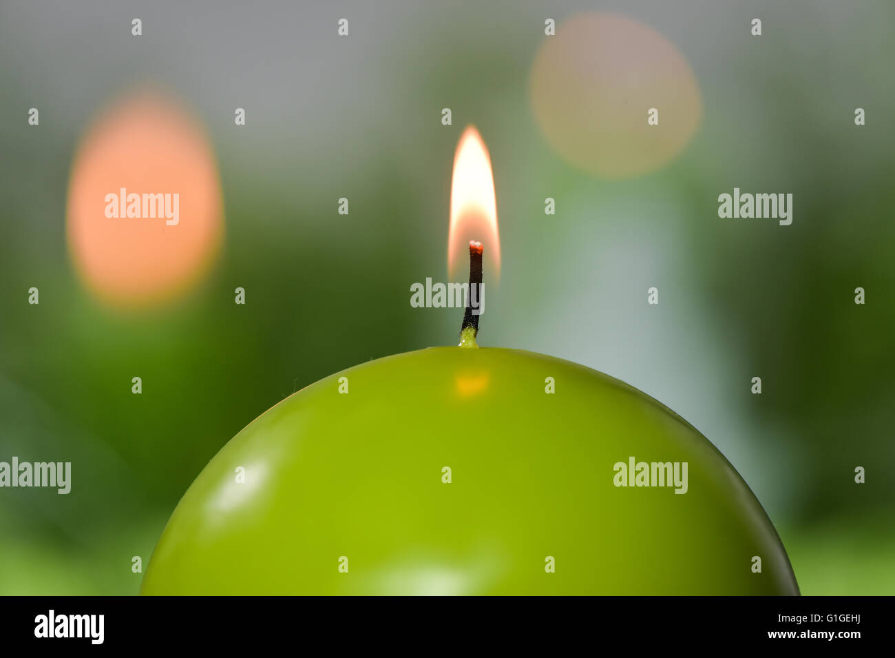 Burning candles Green and red candles studio shoot Stock Photo - Alamy
