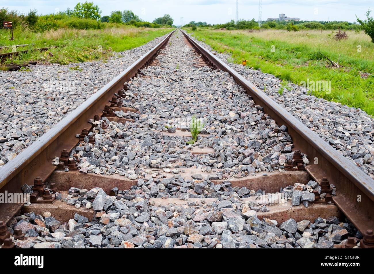 Detail of railway tracks with girder and gravel Stock Photo - Alamy