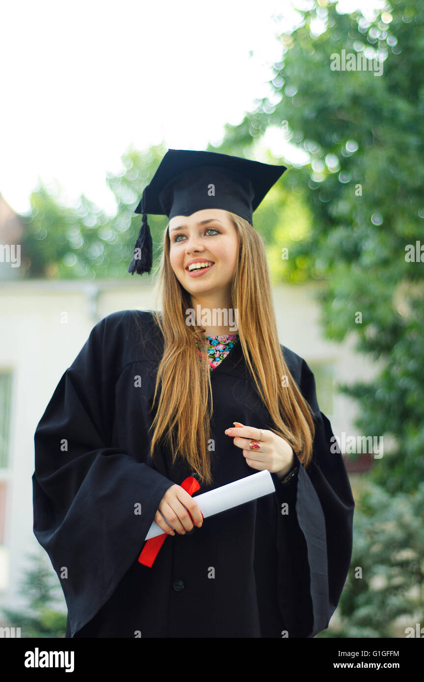 Happy graduate with a diploma in hand Stock Photo - Alamy