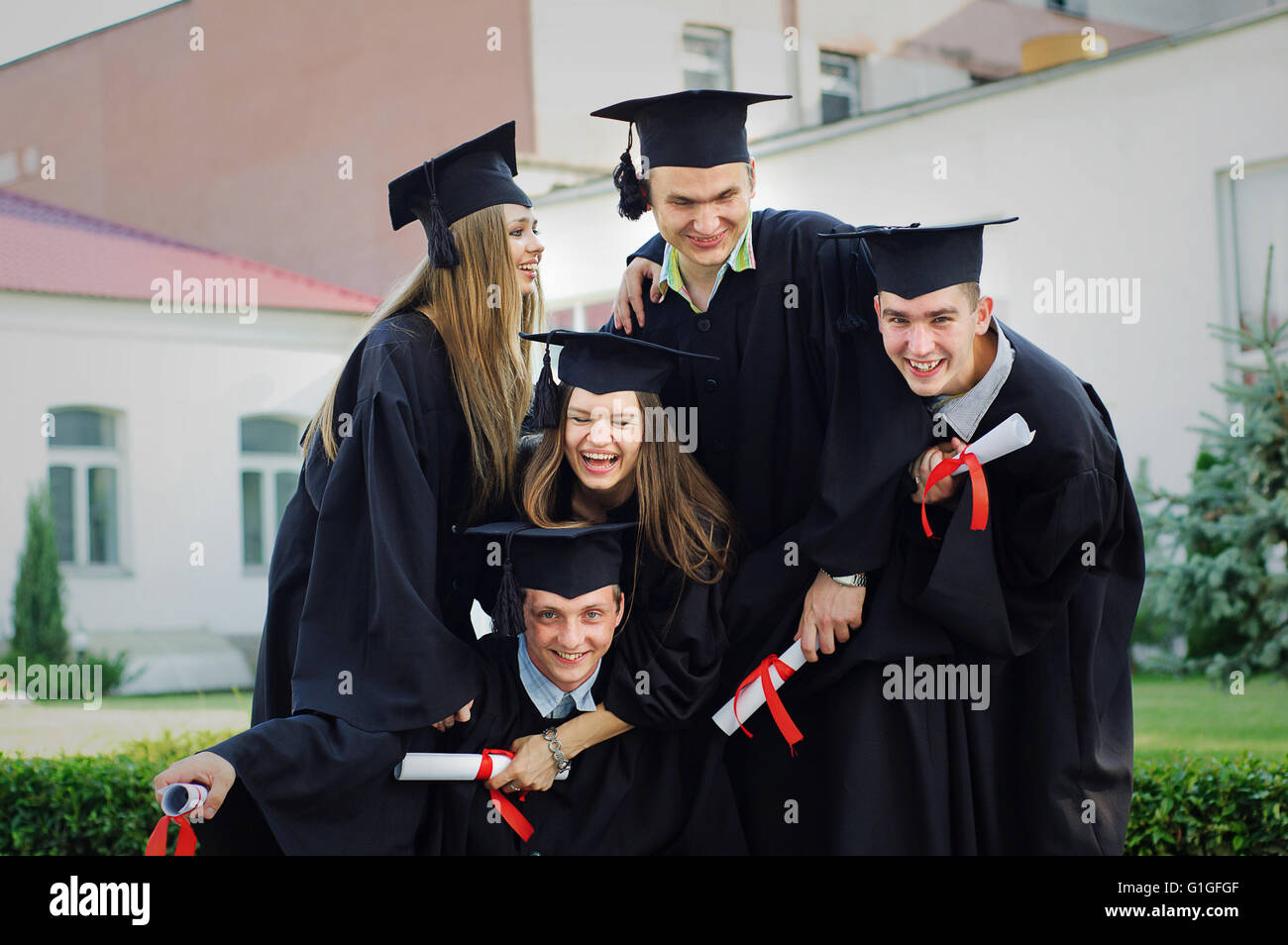 Five university graduates enjoyed their diplomas Stock Photo - Alamy