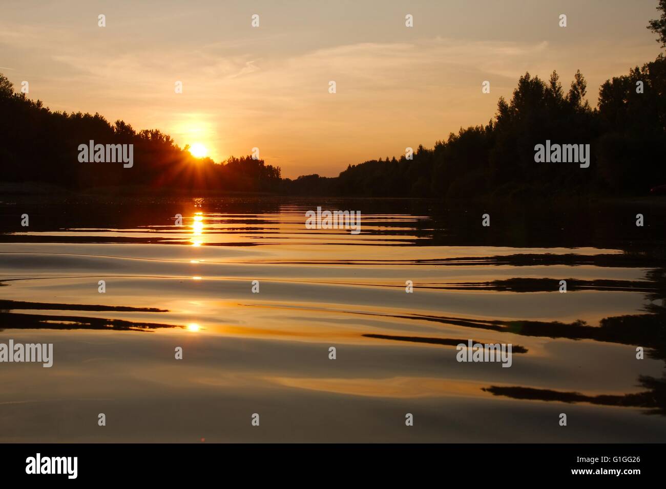 Sunset over a river Stock Photo - Alamy