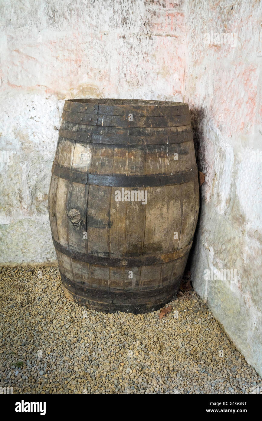 a traditional wooden barrel with iron hoops in the corner of a ...