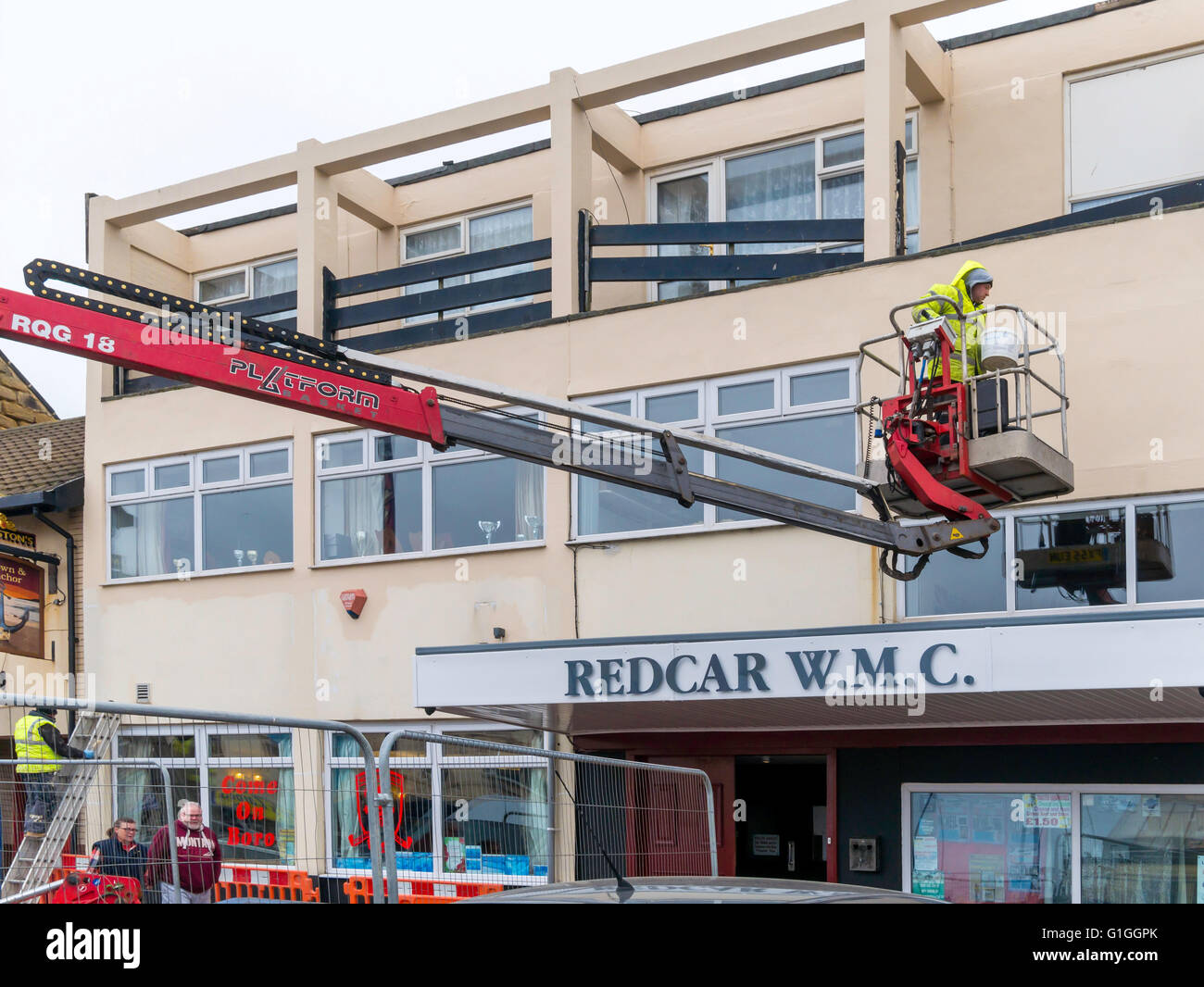 A decorator using an hydraulic access platform for painting the ...