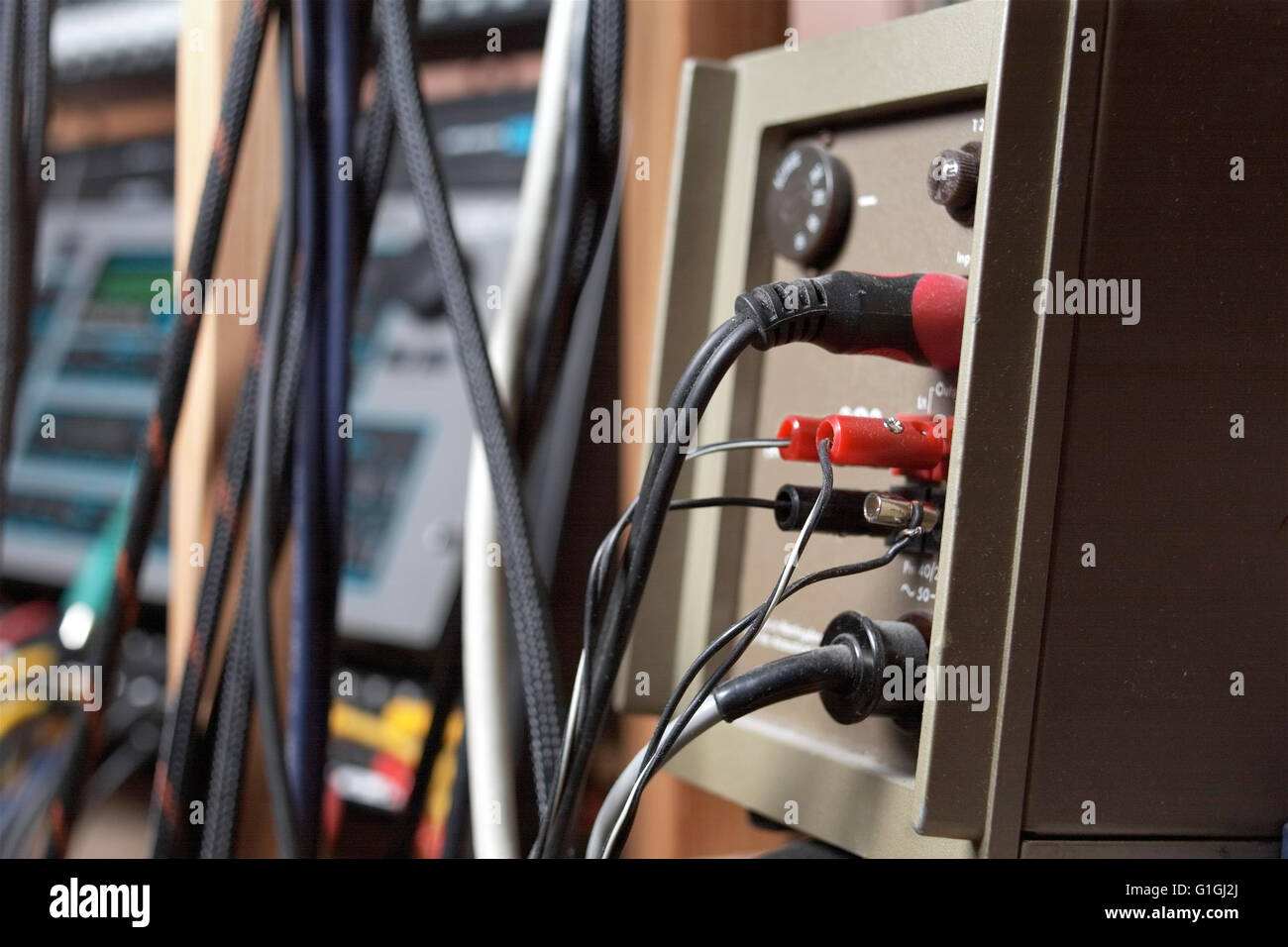 Closeup of a sound amplifier with electric and audio cables, shallow ...