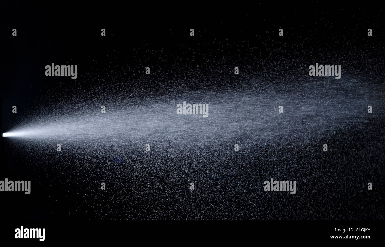 Water jet spraying on black background Stock Photo - Alamy