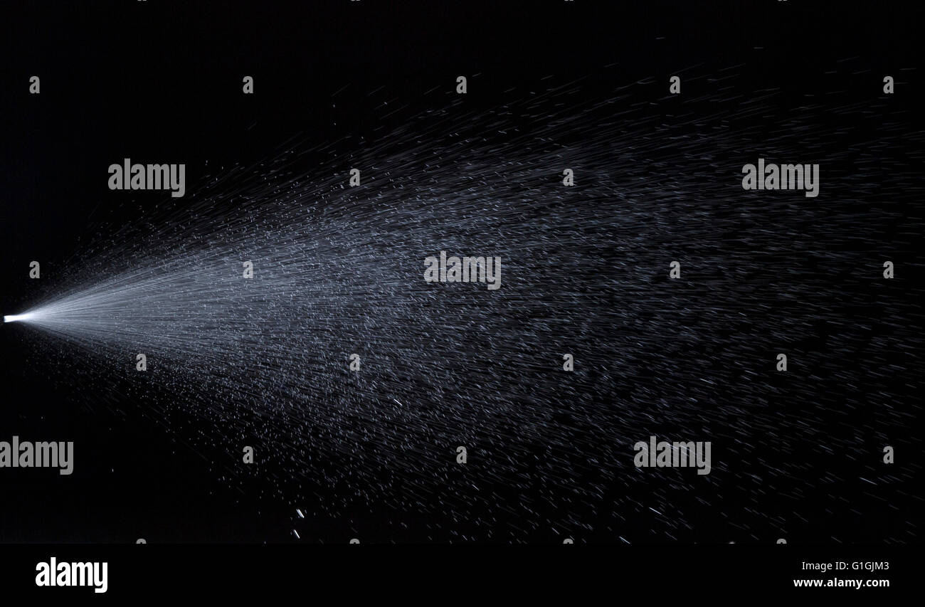 Water jet spraying on black background Stock Photo - Alamy