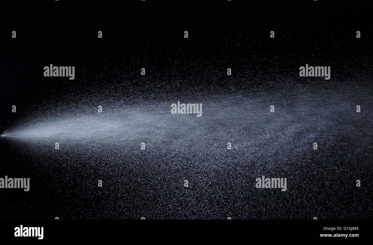 Water jet spraying on black background Stock Photo - Alamy