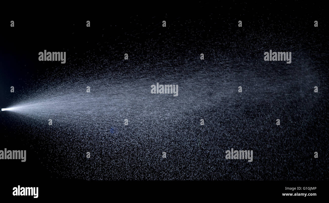 Water jet spraying on black background Stock Photo - Alamy