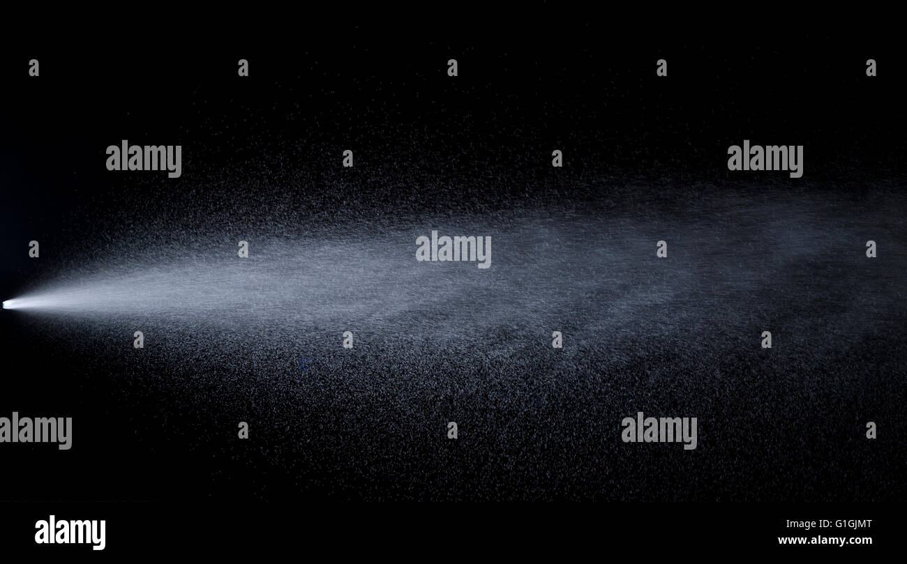 Water jet spraying on black background Stock Photo - Alamy