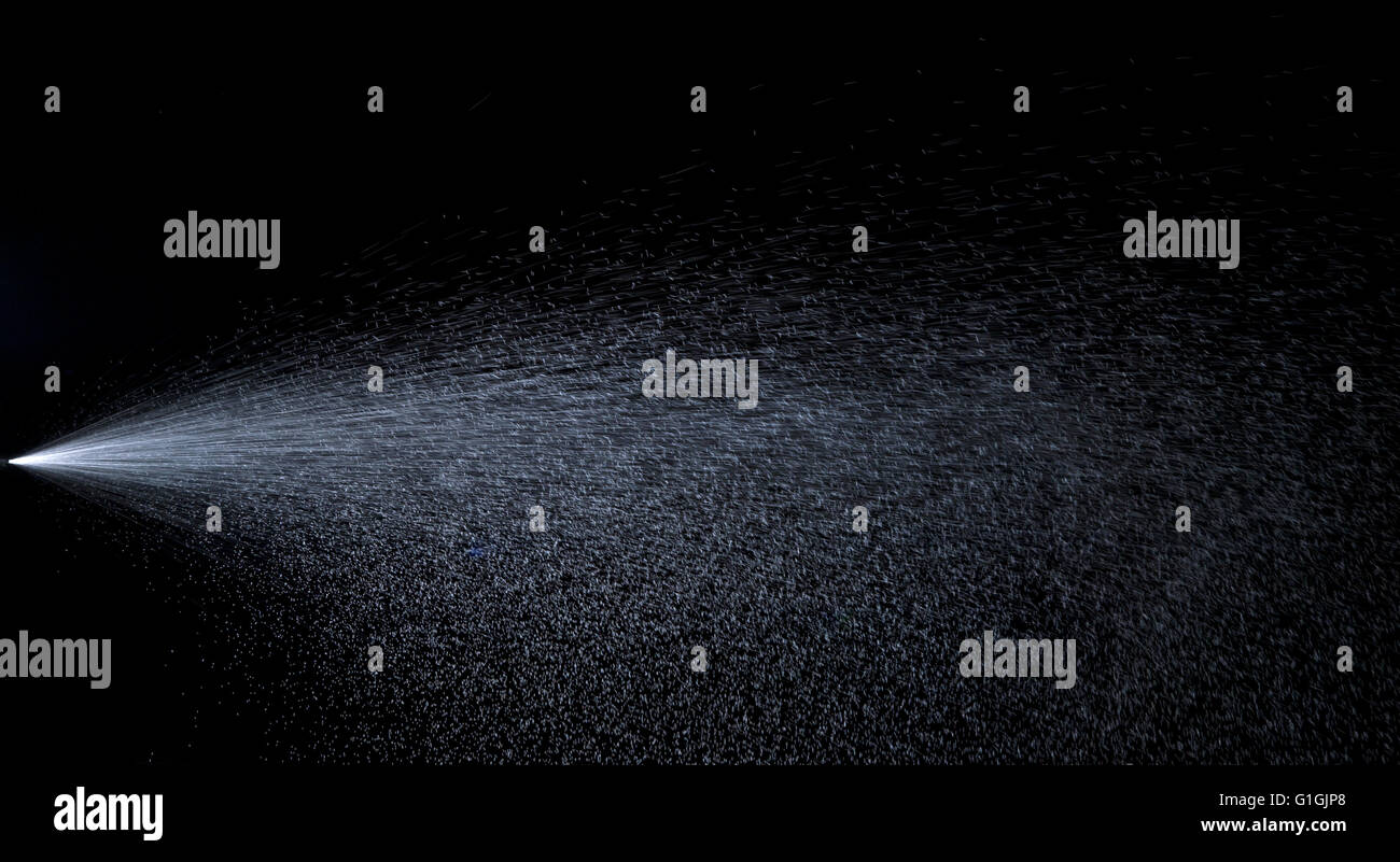 Water jet spraying on black background Stock Photo - Alamy