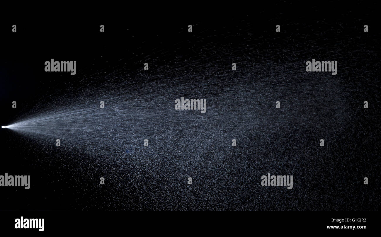 Water jet spraying on black background Stock Photo - Alamy