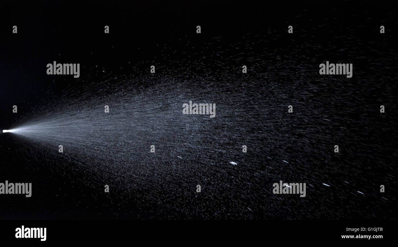 Water jet spraying on black background Stock Photo - Alamy