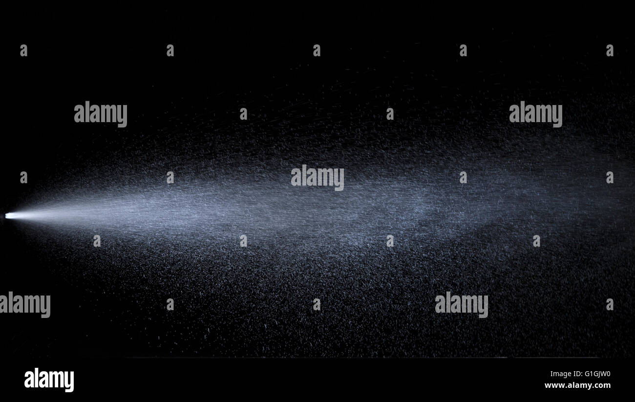 Water jet spraying on black background Stock Photo - Alamy