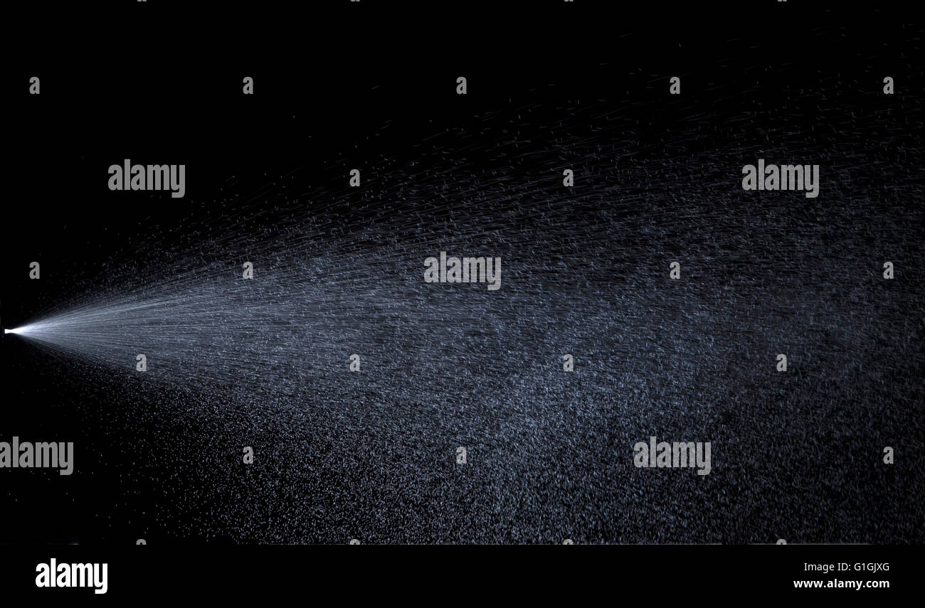 Water jet spraying on black background Stock Photo - Alamy