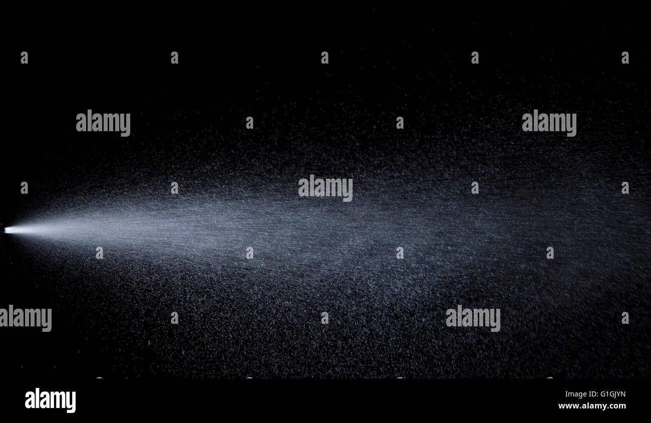 Water jet spraying on black background Stock Photo - Alamy