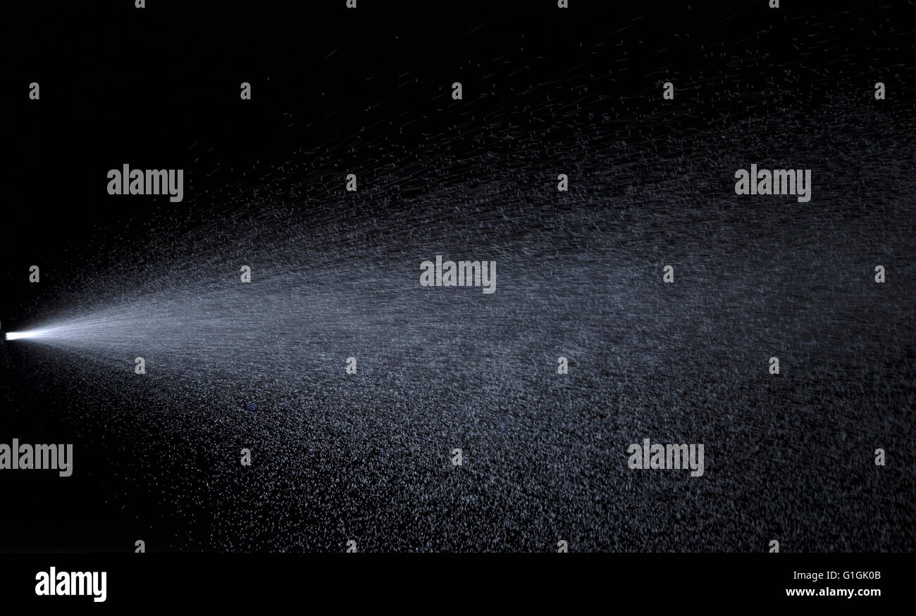 Water jet spraying on black background Stock Photo - Alamy